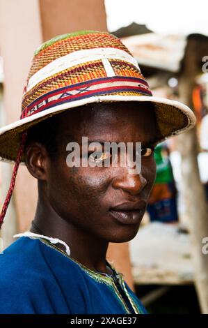 Portrait of a Beninese Muslim man wearing a colorful traditional hat ...