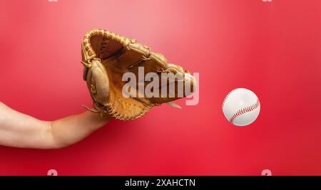 Female baseball gloved hand catches ball. Gray background. Active sport ...