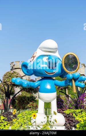 A cheerful Smurf statue in Smurfs Village in Dubai Miracle Garden, UAE ...