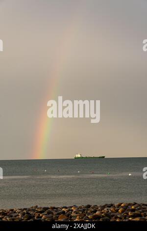 Rainbow and container ship 3 Stock Photo - Alamy