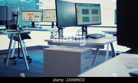 Empty telecommunications control room with workstations, coworking ...