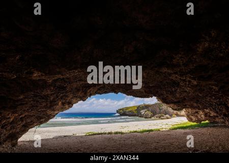 Scenic coastal view at Ladder Beach, Saipan, seen from a cave by the ...