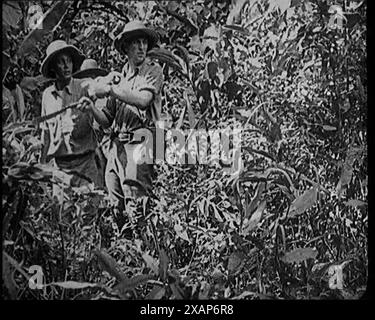 Female Civilians Wearing Explorers Outfit Setting up a Camera to Record ...