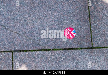 Round vote labour sticker stuck to a pavement slab Stock Photo - Alamy