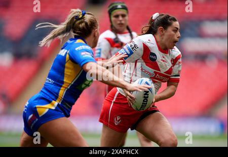 St Helens' Amy Hardcastle (left) skips a tackle during the Women's ...