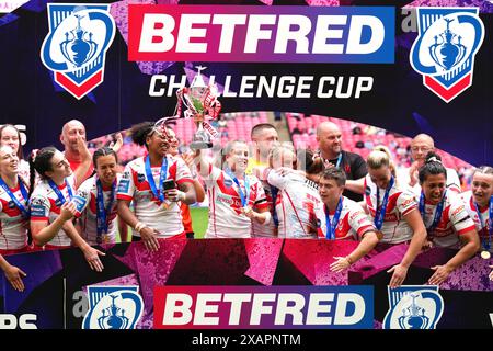 The St Helens players lift the trophy after victory in the Betfred ...