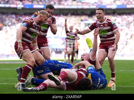 Wigan Warriors' Liam Farrell (centre bottom) celebrates scoring his ...
