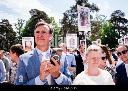 It's a sea of placards and mobile phones as friends and families ...