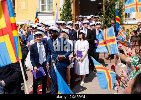 The new graduates emerge from their school for the final time to a ...