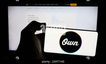 Cellphone with logo of American data platform business Own Company ...