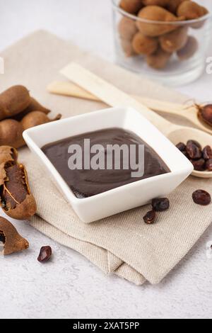 Bowl with tasty tamarind jam with fruits on white background Stock ...