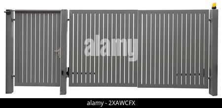 Gray metal driveway entrance gates set in brick fence with lock Stock ...