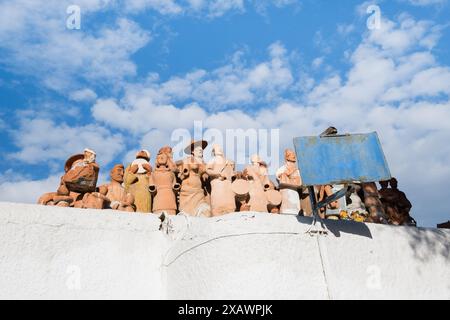 Several typical Moroccan terracotta pottery on the roof of a low shop ...