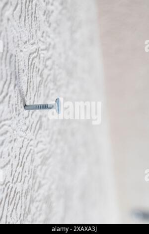 Nail driven into the wall Stock Photo - Alamy