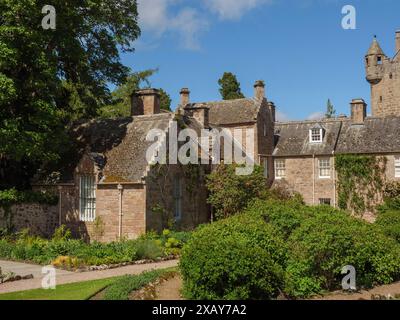 Old stone house surrounded by dense, green trees and plants Stock Photo ...