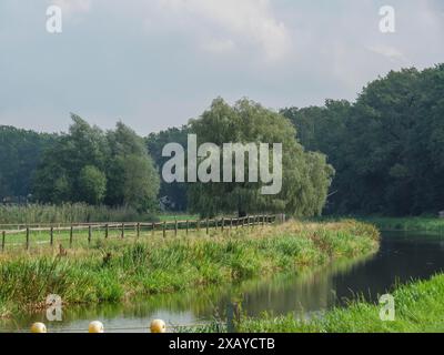 A large green meadow under a cloudy sunset sky Stock Photo - Alamy