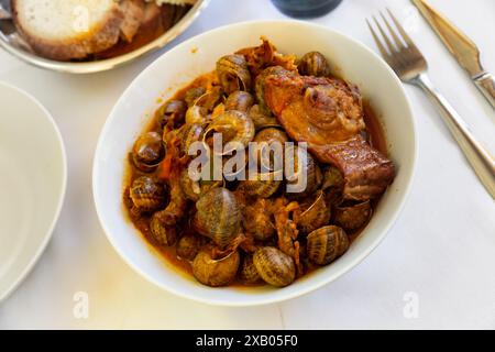 Stewed snails with rabbit meat and sausages Stock Photo - Alamy