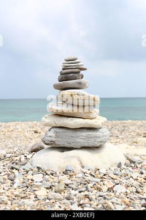 Sandstone are stacked into a pyramid shape on sea and cloud background ...