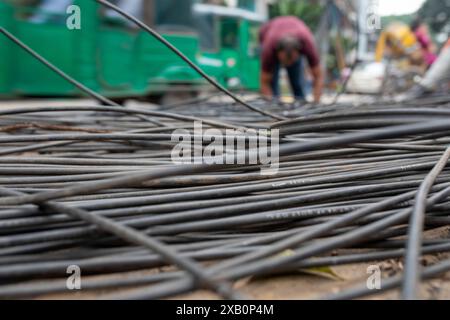 Workers repairing overhead internet cables damaged by a storm in Dhaka ...