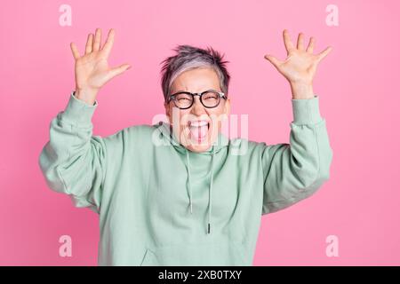 Photo of funky cool girl dressed green clothes shooting money gun empty ...
