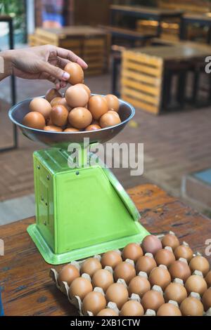 stack of chicken eggs being weight by merchant Stock Photo - Alamy