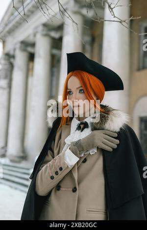 Cold redhead wearing coat and hat against peaceful autumn scene in ...