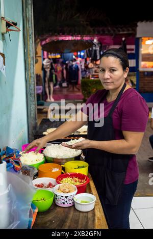 Cook making pupusa, a flatbread made of cornmeal and declared the ...