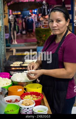 Cook making pupusa, a flatbread made of cornmeal and declared the ...
