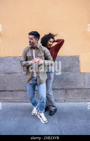 A cheerful multiethnic couple, composed of a Chinese man and a Hispanic ...