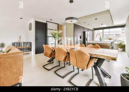 Comfortable chairs with cushions and sofa located near table under ...