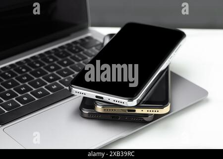 Stack of electronic devices on a white desk Stock Photo - Alamy