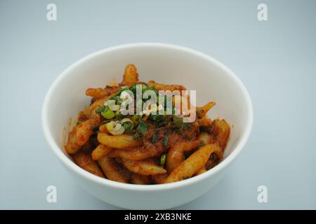 A bowl of spicy lou shu fan with spring onions on top and white ...