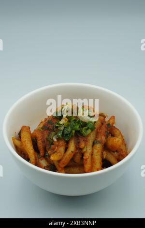 A bowl of spicy lou shu fan with spring onions on top and white ...