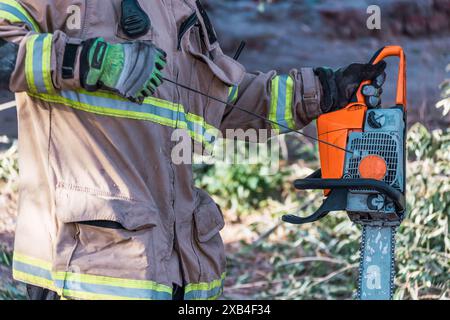 Firefighter starting chainsaw, in rescue Stock Photo - Alamy