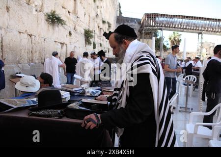 Ultra Orthodox Jew wearing a Talith and Tefillin prays with other Jews ...
