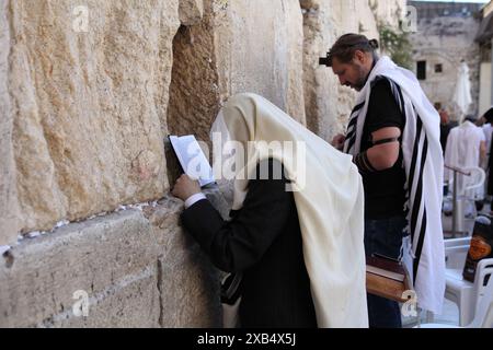 Ultra Orthodox Jew wearing a Talith and Tefillin prays with other Jews ...