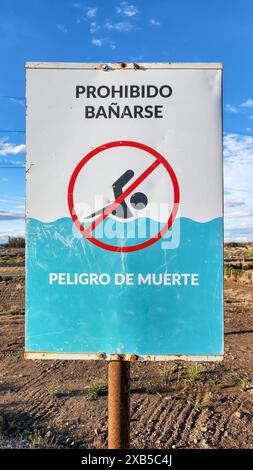 Poster prohibiting bathing, with text in Spanish. Danger of death Stock ...