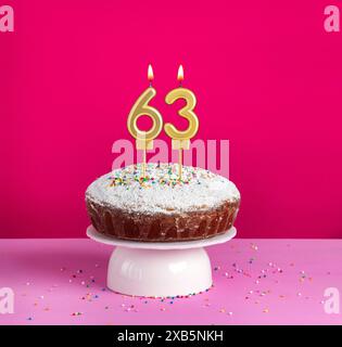 Pink number 63 birthday candle on white background Stock Photo - Alamy