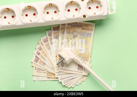 Bulgarian lev banknotes with plug and power socket on green background ...