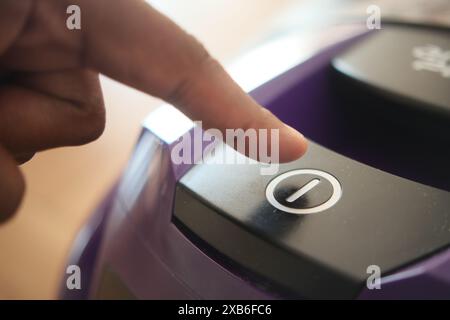 pressing start button on vacuum cleaner Stock Photo - Alamy