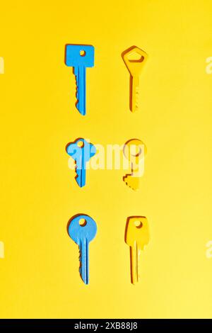 Various colorful keys on vibrant yellow background. Flat lay Stock ...