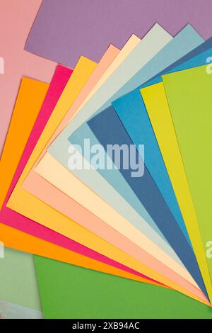 sheets of colored paper. Many colored sheets of paper are laid out in ...