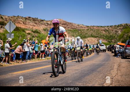 The cyclists participating in a mountain bike race with spectators ...