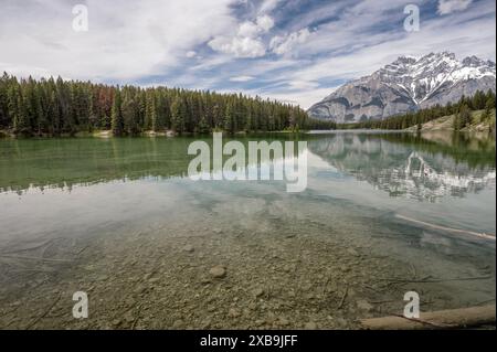 Cascade Mountain reflected in Johnson Lake, Alberta, Canada Stock Photo ...