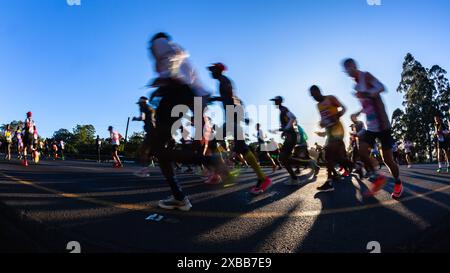Marathon runners motion speed blurs silhouetted morning dawn sunrise ...