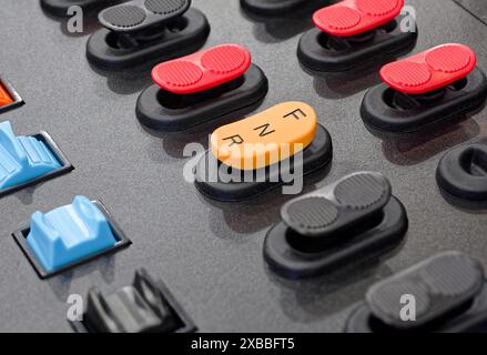Black control panel with accorted buttons and switches. Abstract ...
