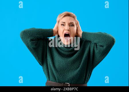 Screaming scared mature woman on light blue background Stock Photo - Alamy