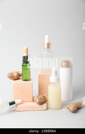 Composition with bottles of cosmetic products, ginger and plaster ...