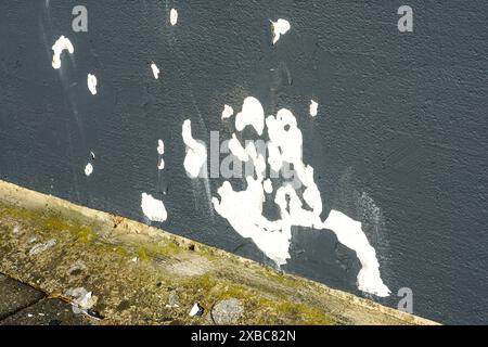 Detachment of fragments of the facade wall paint layer from the wall ...