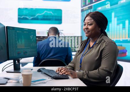 Chief executive officer reviews data shown on big display in the office ...
